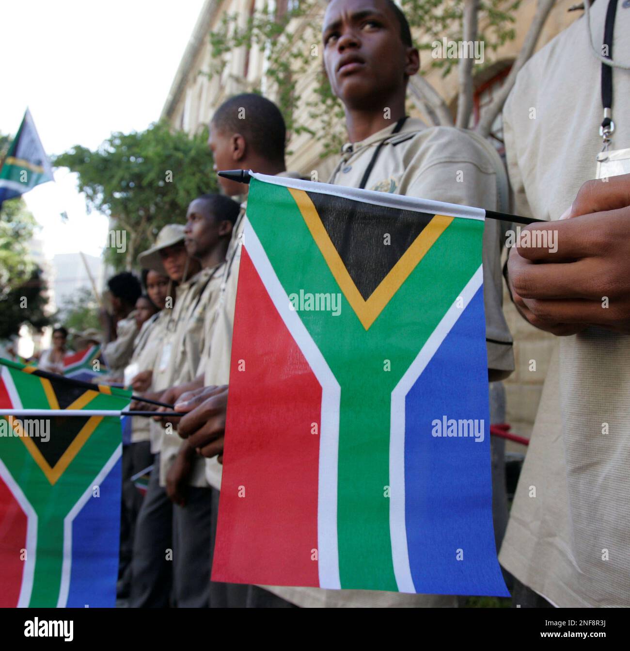 Children hold South African flags before the opening ceremony of ...