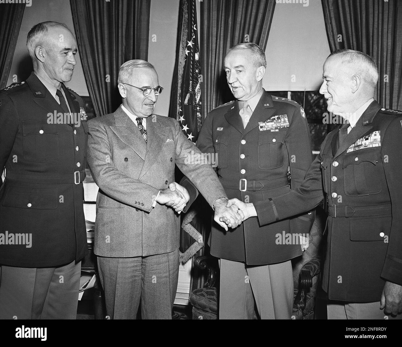 President Harry Truman congratulates two retiring Army generals on ...