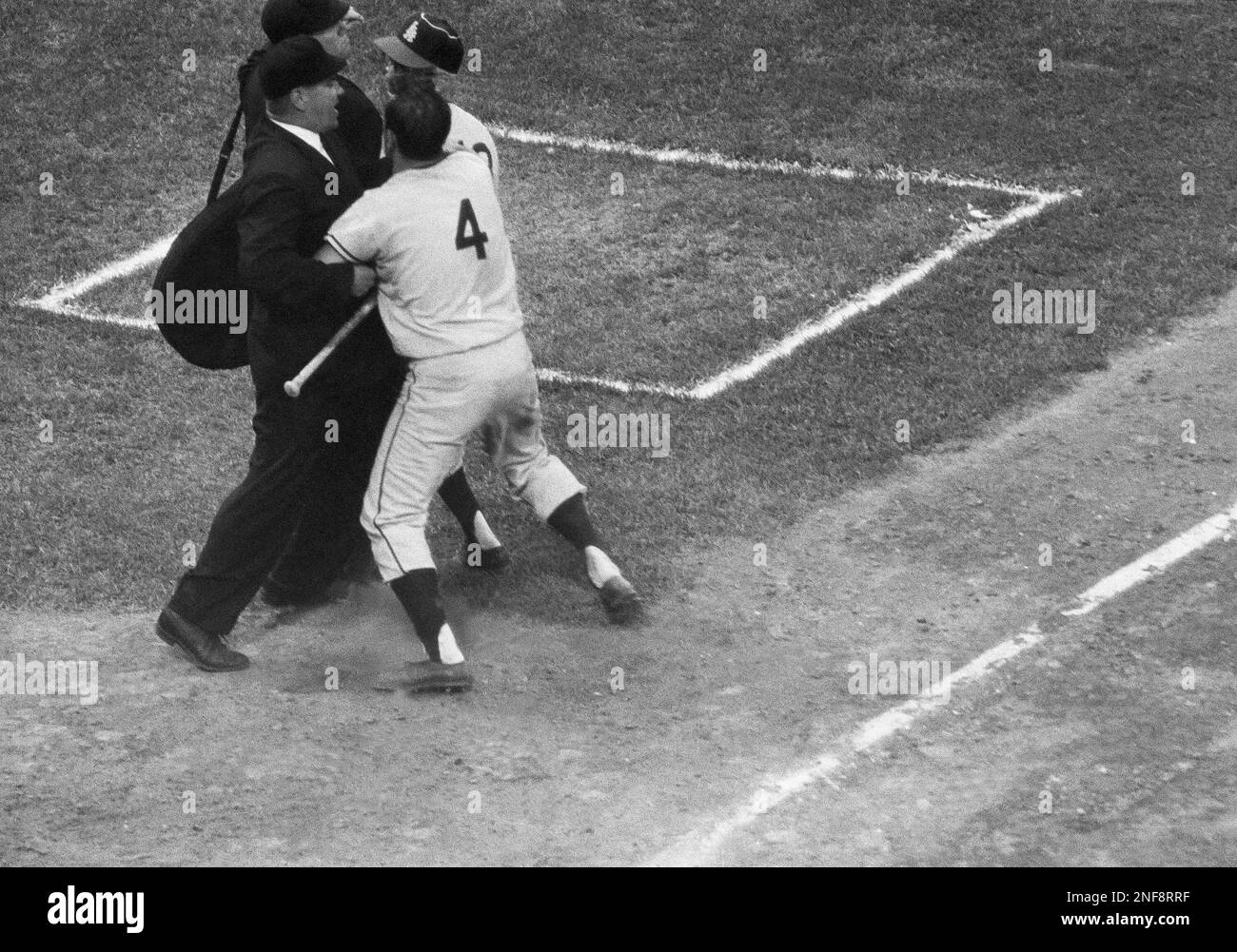 Los Angeles Angels' Jimmy Piersall grapples with two umpires during an ...