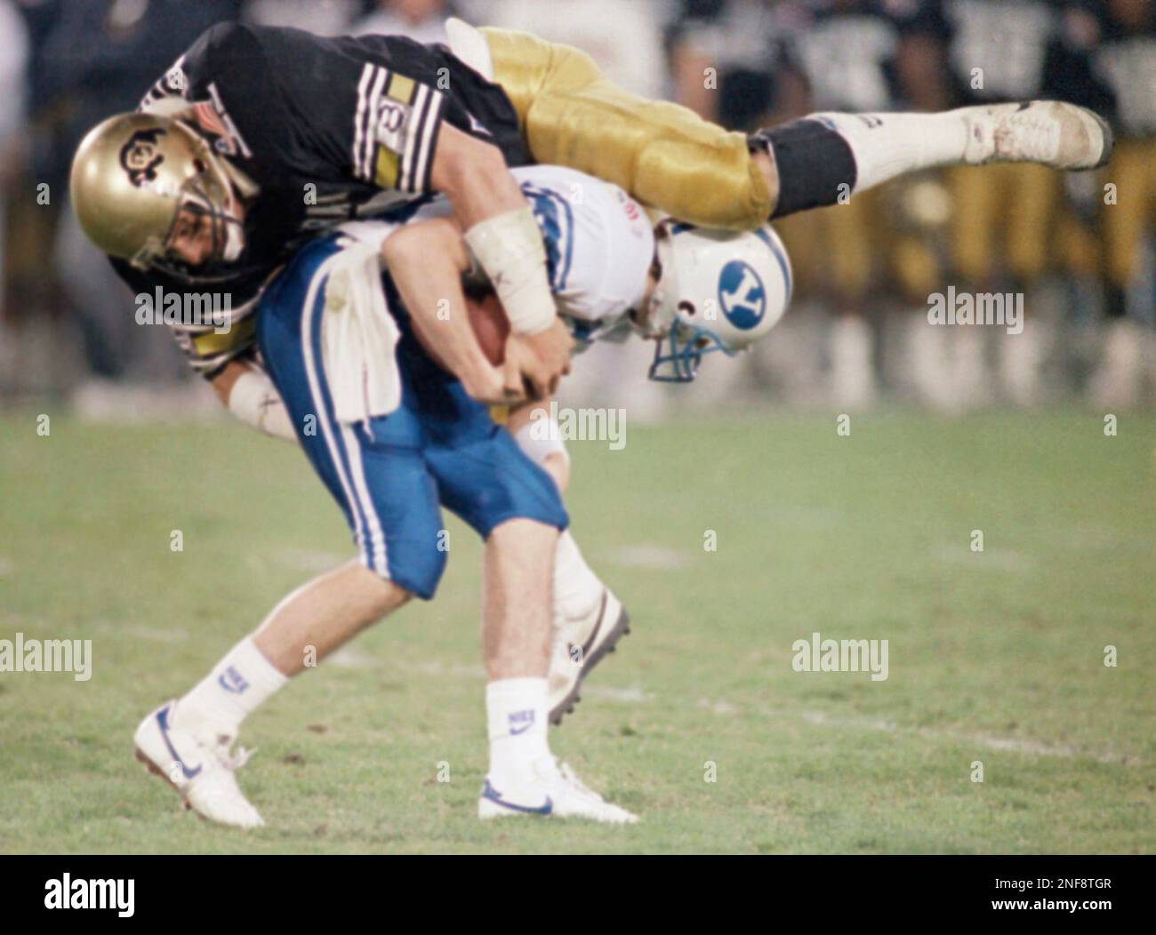 Colorado linebacker Don DeLuzio attempts to stop BYU fullback Fred ...