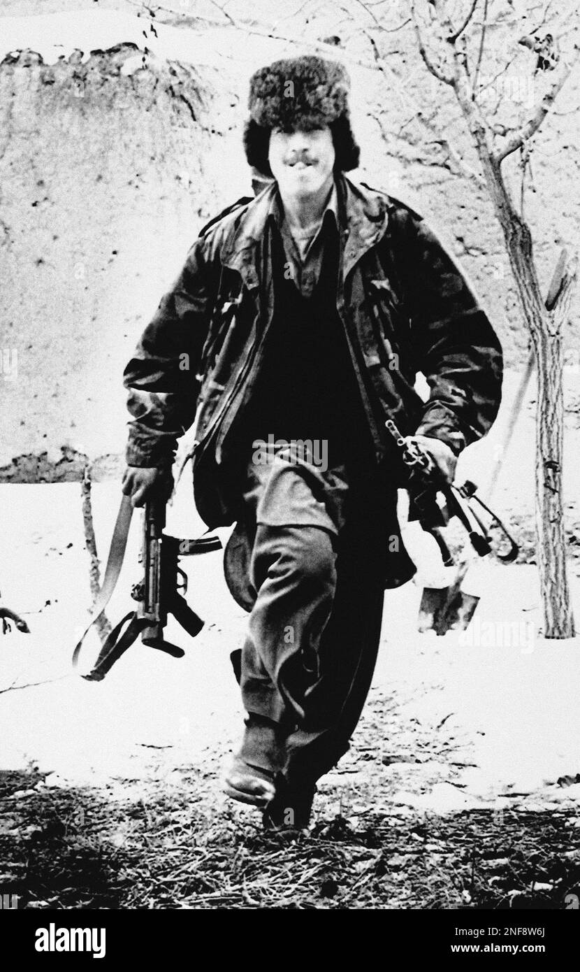An Afghan guerrilla runs for cover from incoming mortar and tank shells ...