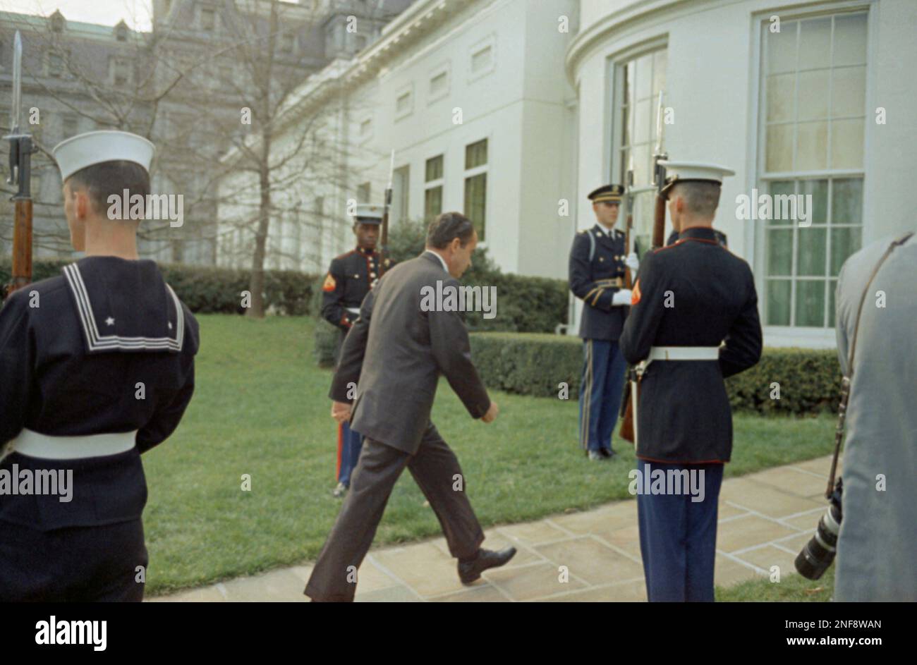 President Richard Nixon, center, strides back to the Oval Office after ...