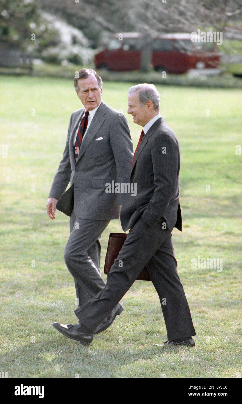 President George Bush and Secretary of State Jams A. Baker III walk across the South Lawn of the ...