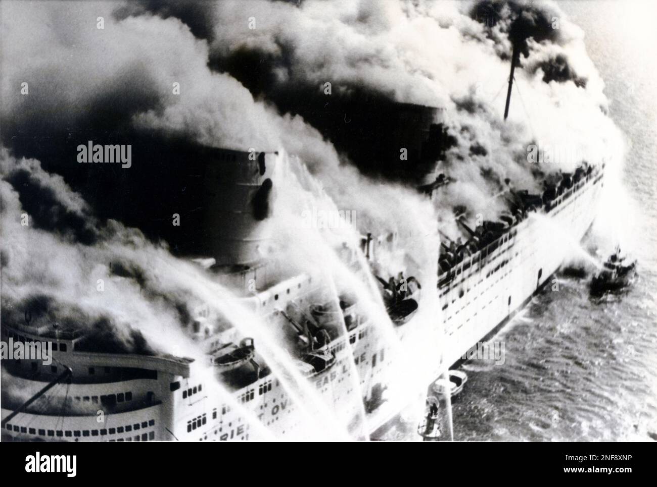 Fire boats spray water on the burning Luxury Liner Queen Elizabeth, now ...