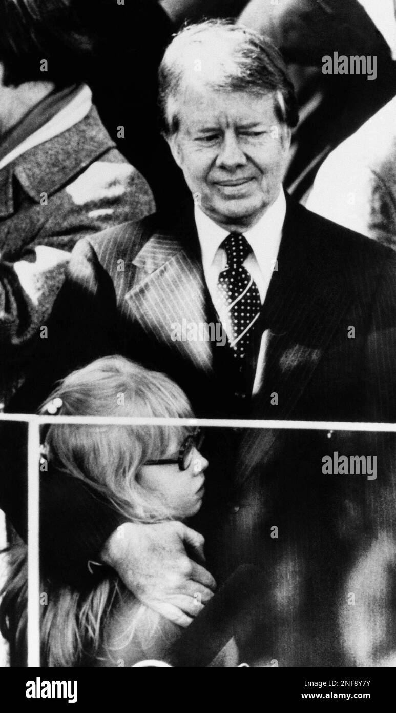 Pres. Jimmy Carter, center, embraces his daughter Amy Carter on the ...