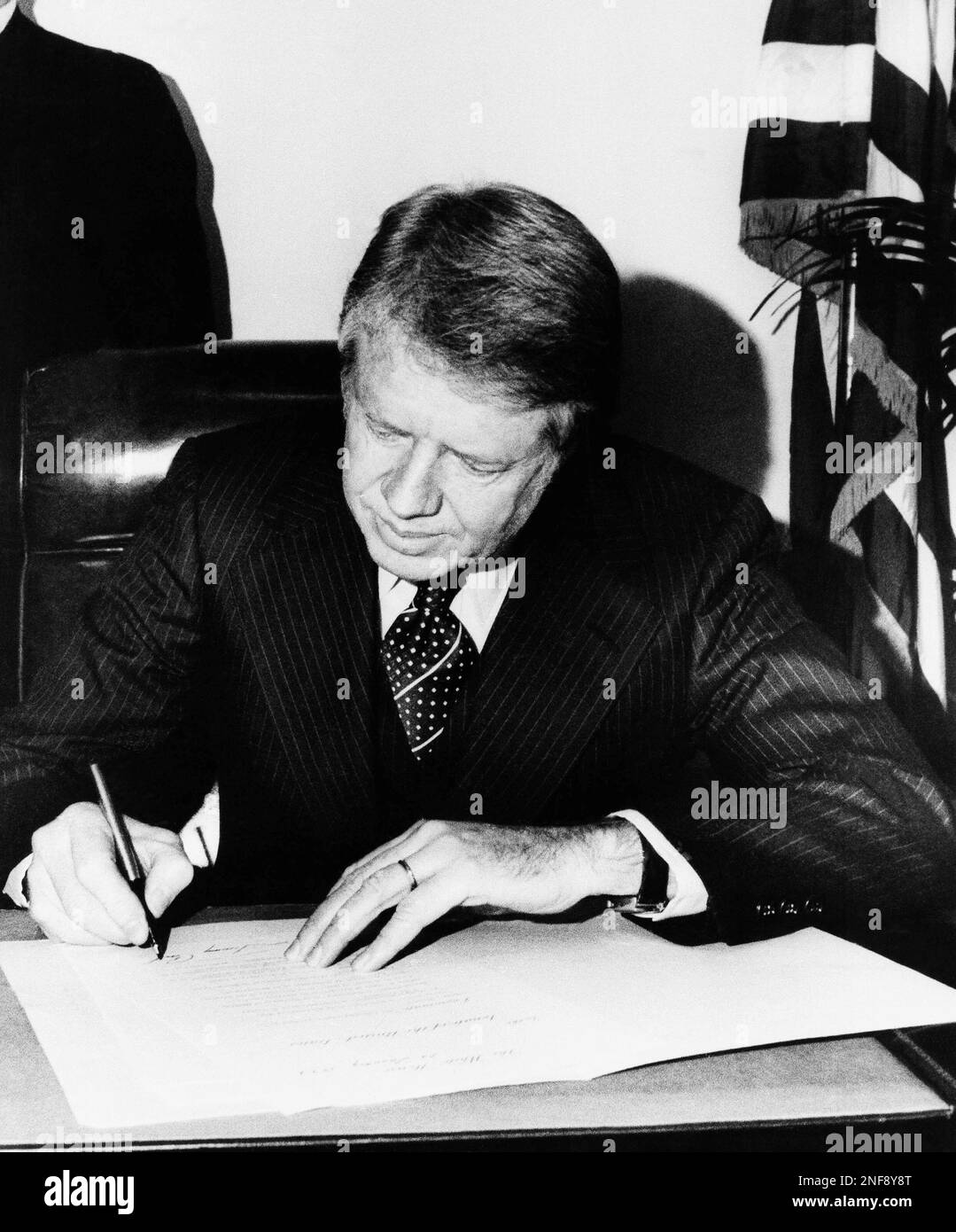 Pres. Jimmy Carter signs the papers submitting the names of his cabinet ...