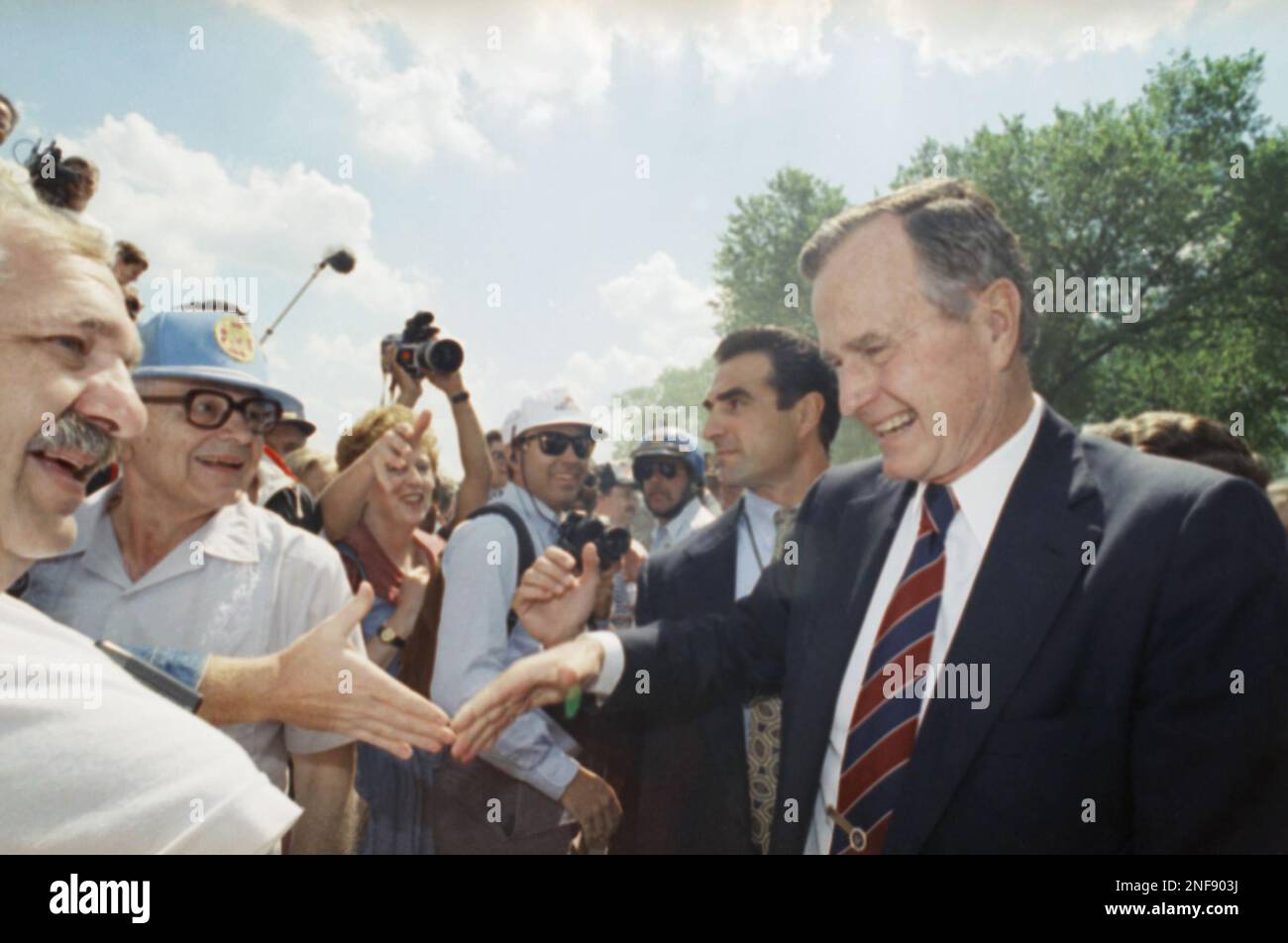 President George Bush reaches out to shake hands on the Mall in ...