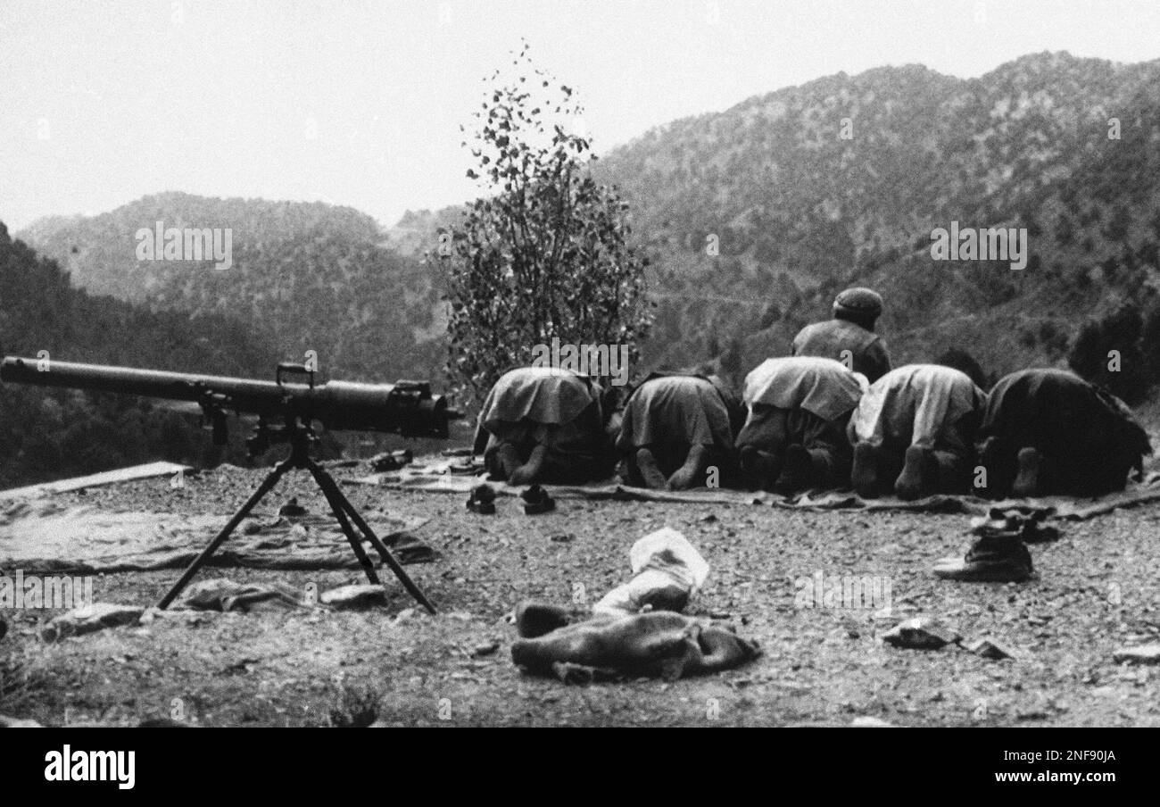 Mujahedeen of the National Islamic Front pray at a small military base ...