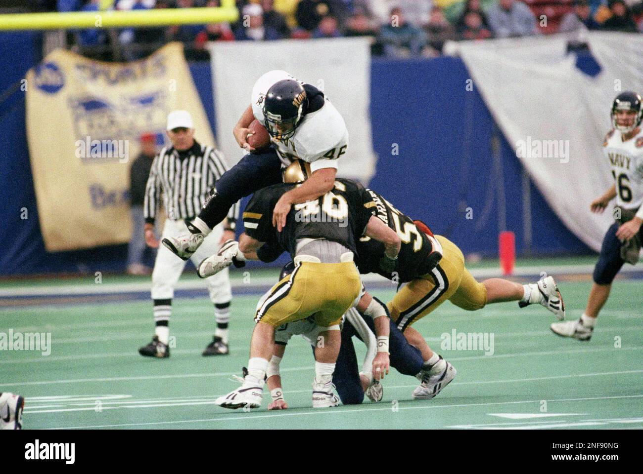 Navy’s Brad Stramanak gets pushed into the air by Army’s Eric Oliver ...