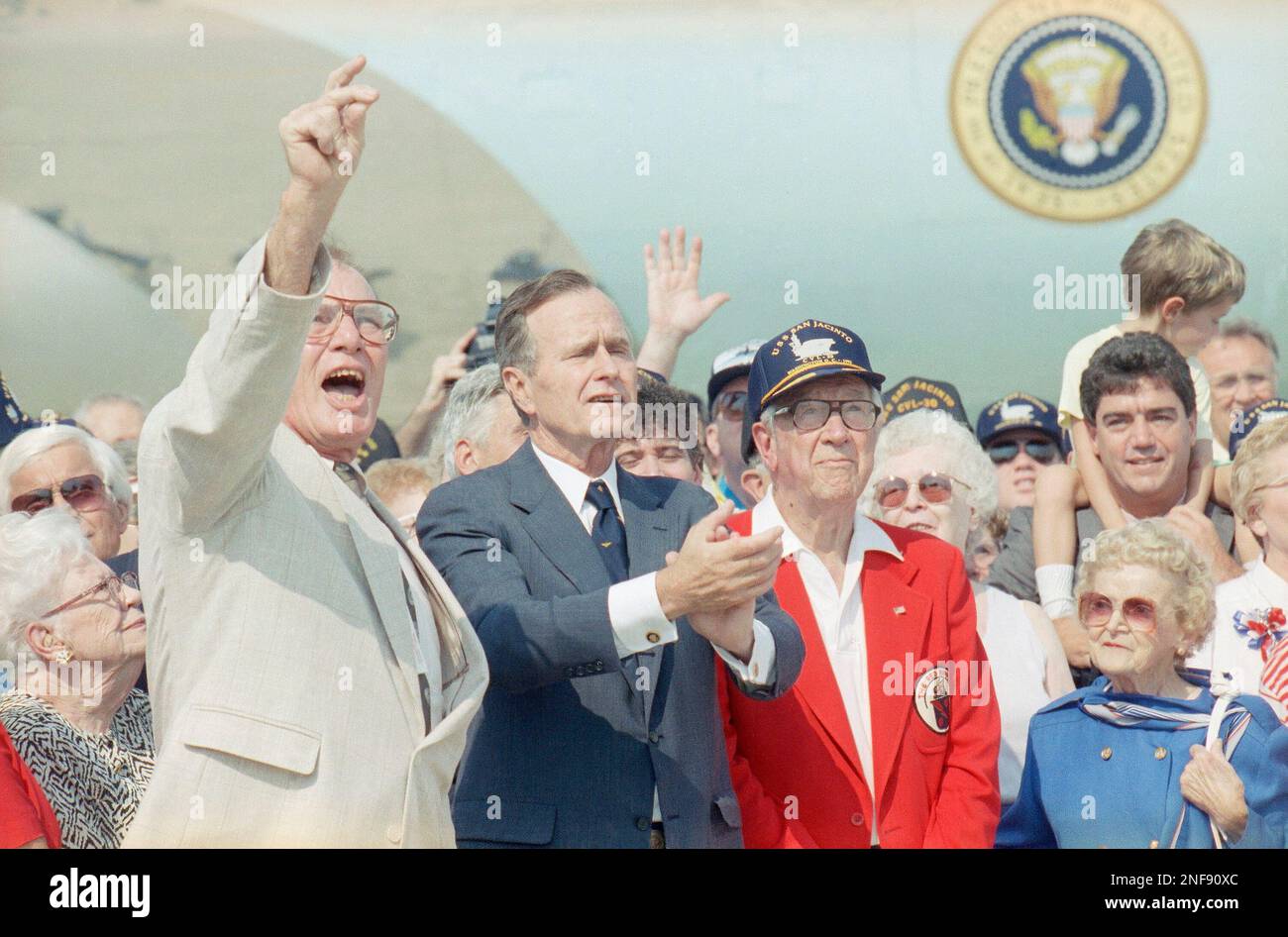 President George Bush reacts along with his comrades-in-arms to a fly ...