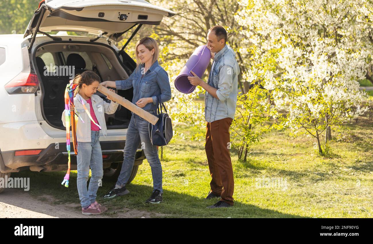 Travel car and camping luggage packed in the full car trunk. Outdoor ...