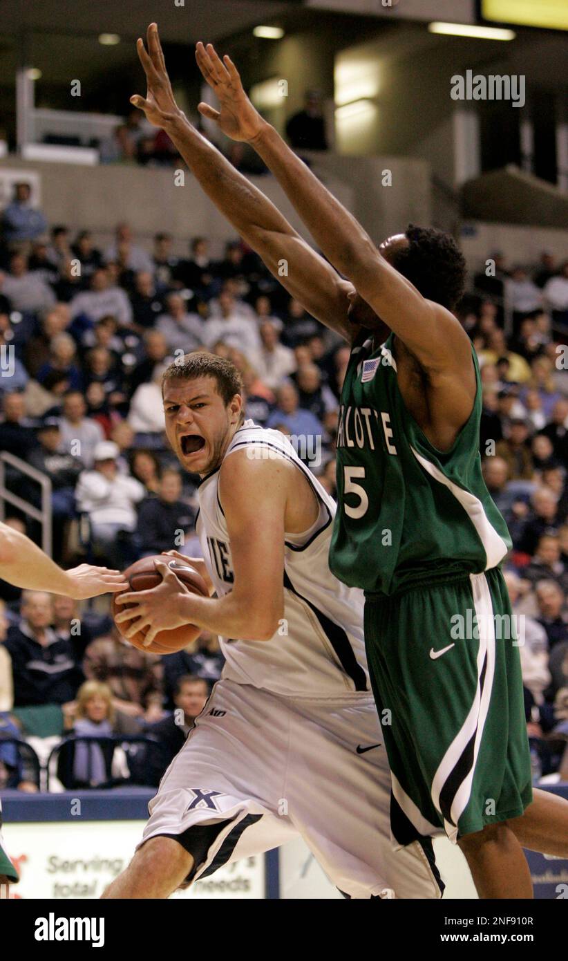 Xavier center Kenny Frease, left, plays against Charlotte forward Gaby ...