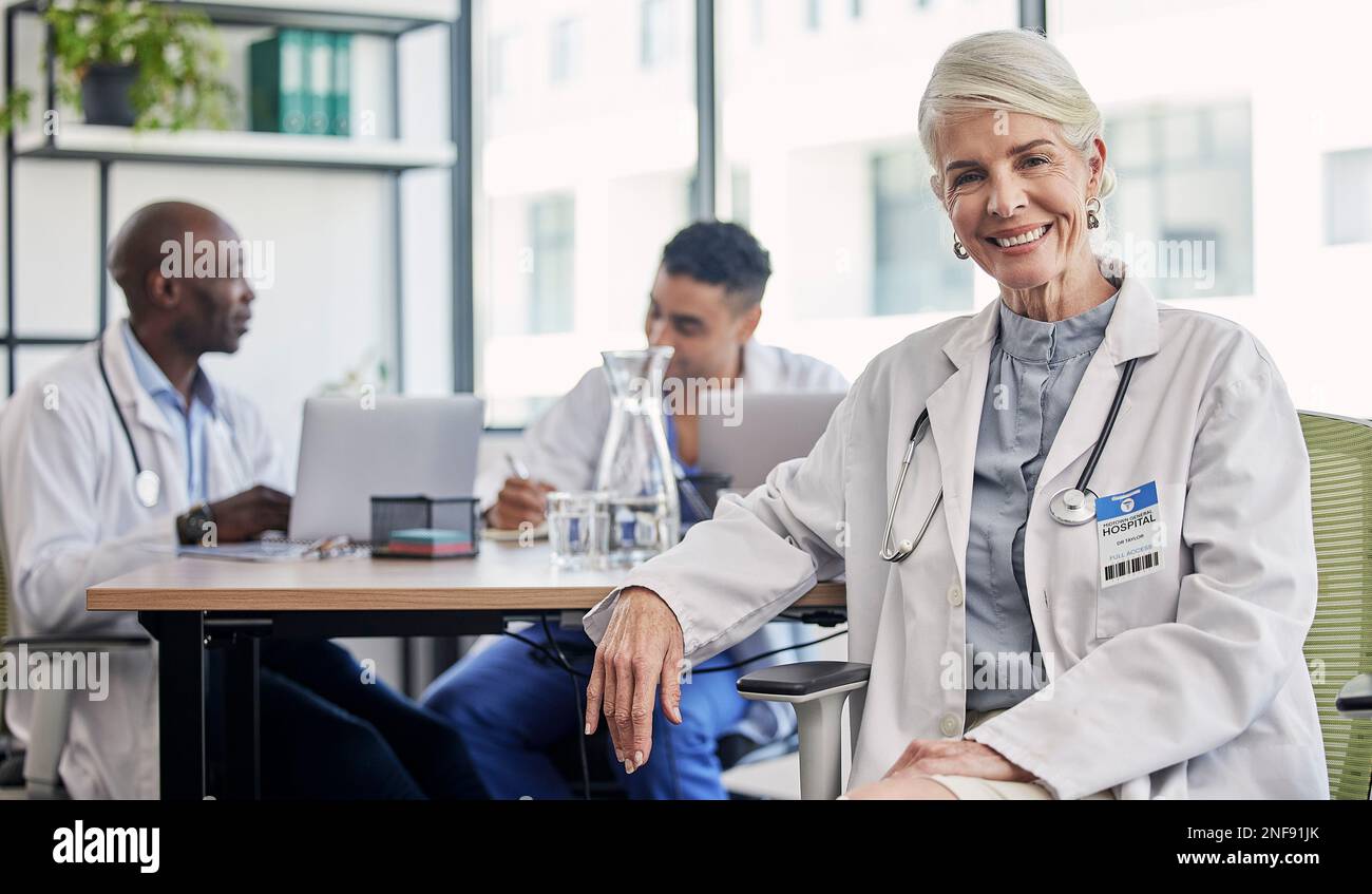 Senior woman, doctor and portrait at hospital desk with smile for healthcare, planning surgery ...