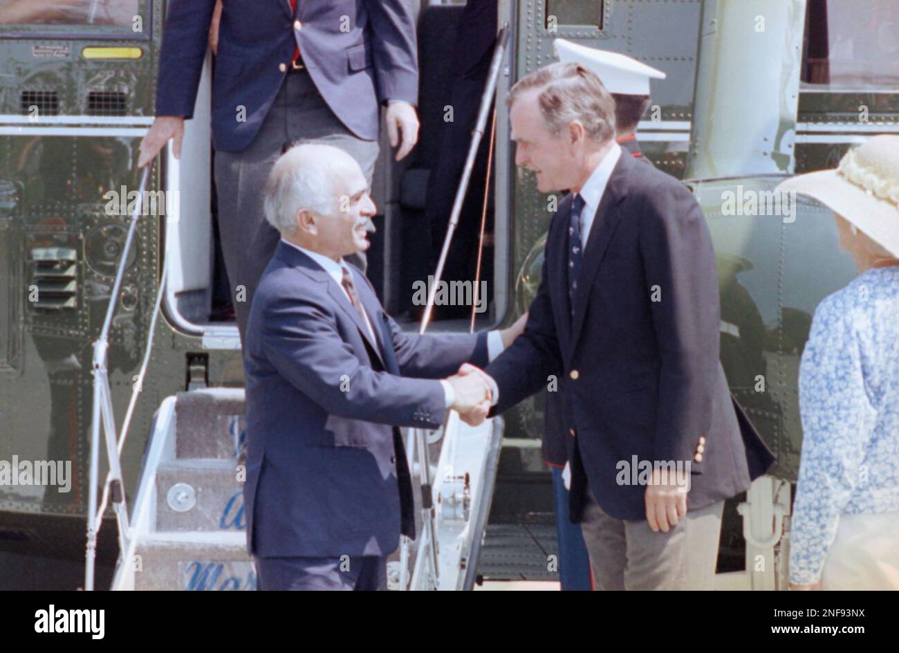 U.S. President George H. Bush greets Jordan's King Hussein as he ...