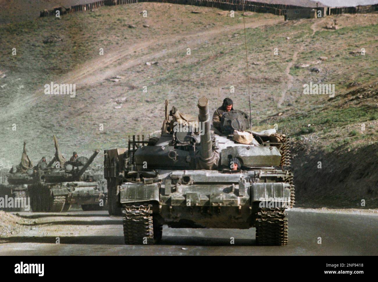 With their machine guns covered with tarpaulin, a convoy of Soviet M-72 ...
