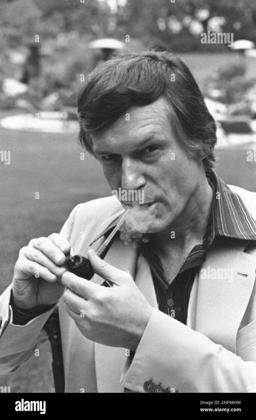 Playboy publisher Hugh Hefner lights his pipe during a recent interview ...