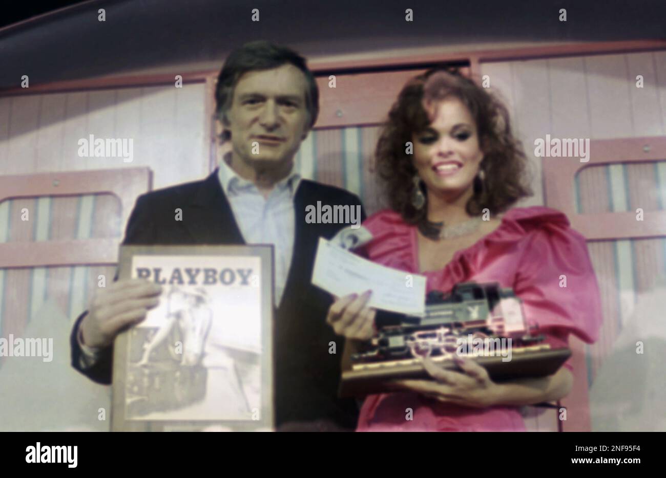 Hugh Hefner, left, poses with Playmate of the Year for 1984 Barbara ...