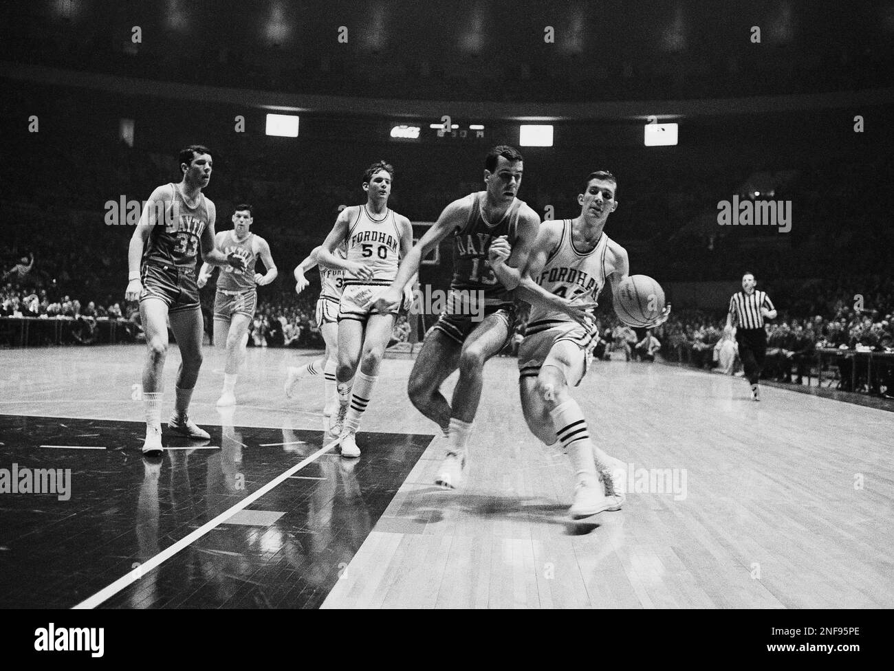 Jim Gottschall (13) of Dayton fouls Fordham’s Frank McLaughlin, right ...