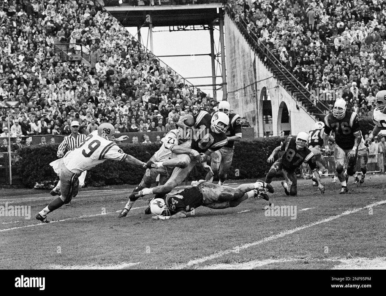 University of Wyoming quarterback Paul Toscano (10) comes crashing down ...