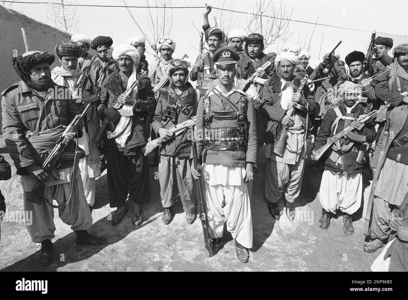 A mujahedeen, a captain in the Afghan army before deserting, poses with ...