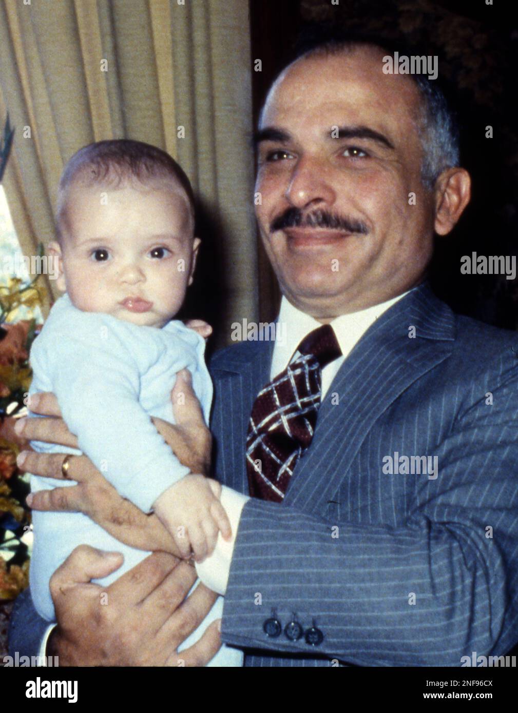 King Hussein of Jordan, proudly holds his four-month-old son, Hamza, during a visit to Gymnich ...