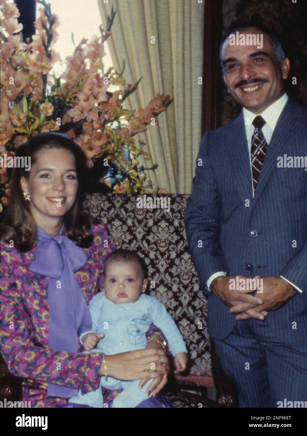 King Hussein of Jordan and Queen Noor al-Hussein, flank their four-month-old son, Hamza, during ...