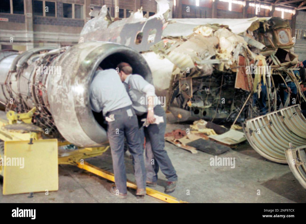 Two Continental Airlines employees breakdown one of the engines from ...