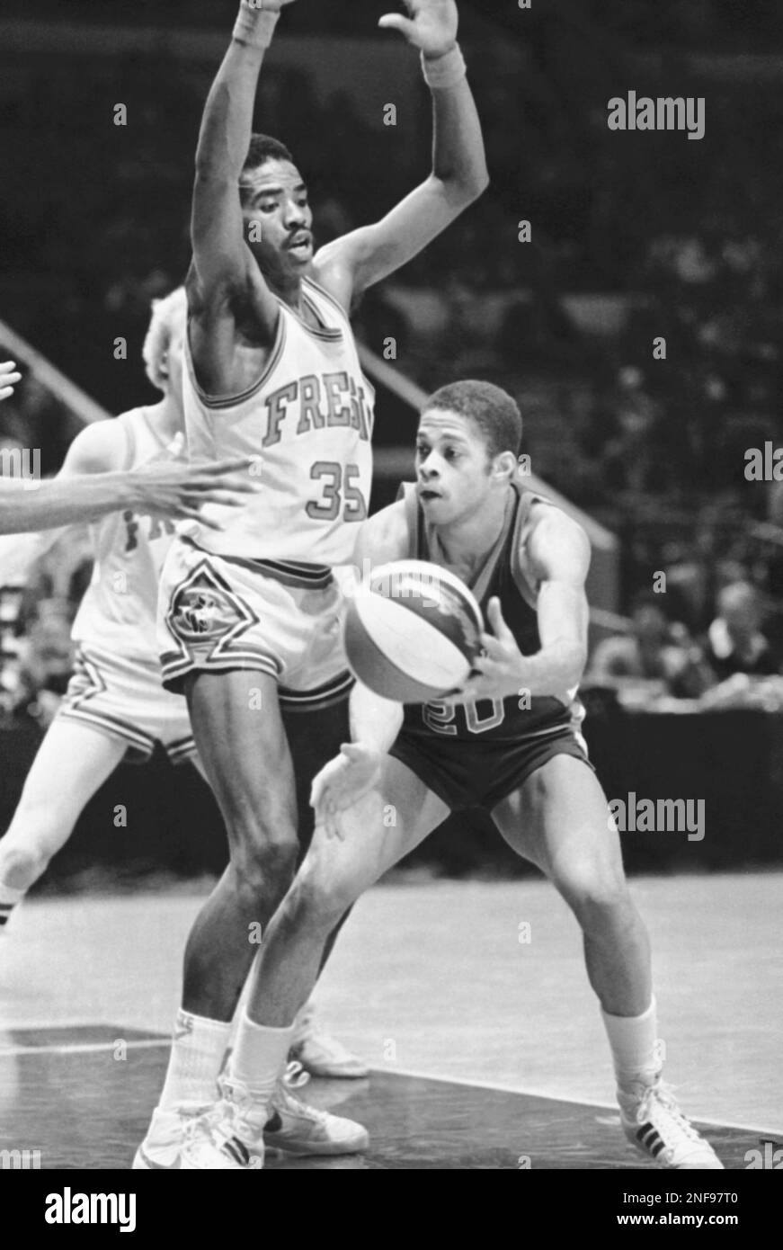 DePaul University's Tony Jackson passes around Fresno State's Ron ...