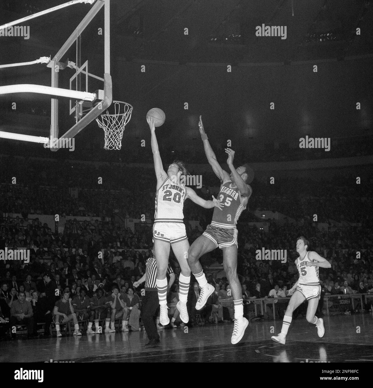 St. John's Mike Keilty (20) takes down a rebound as Niagra's Ed Street ...