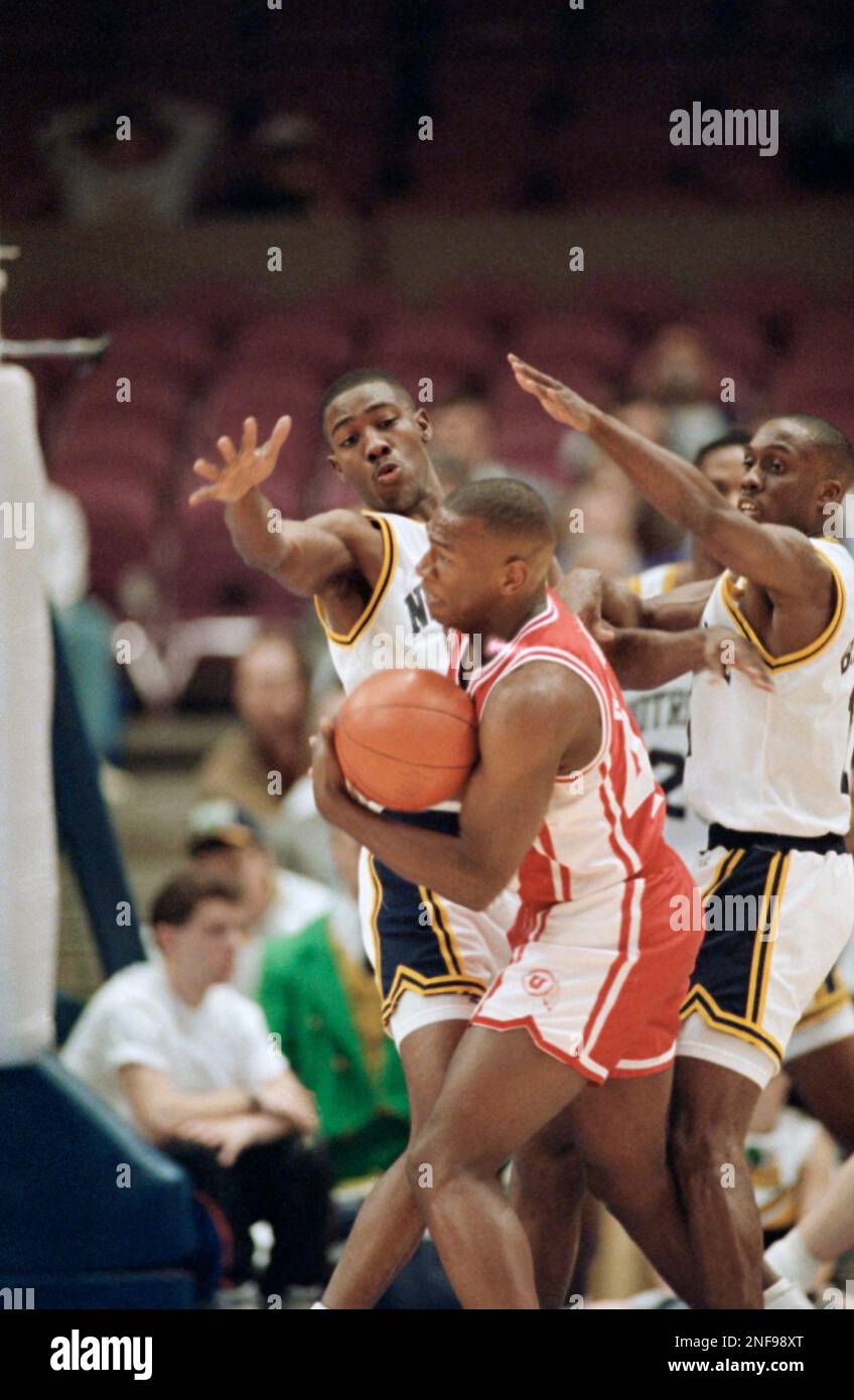 Utah's Byron Wilson, center, looks for help as he is surrounded by ...