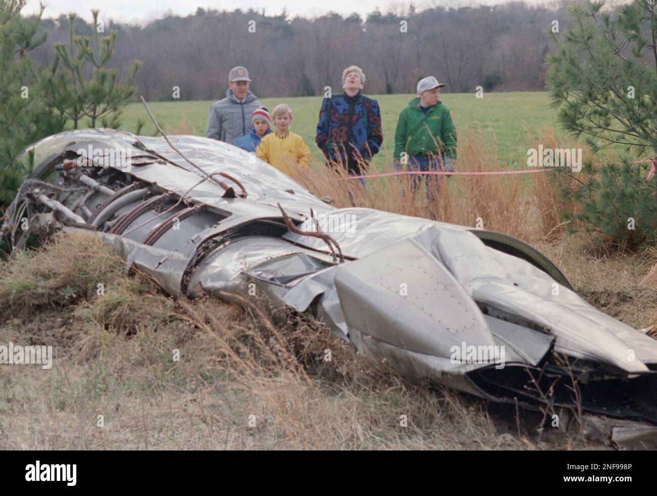 Marilyn Timms looks up as her husband, Dan, left, son, Dereck, center ...