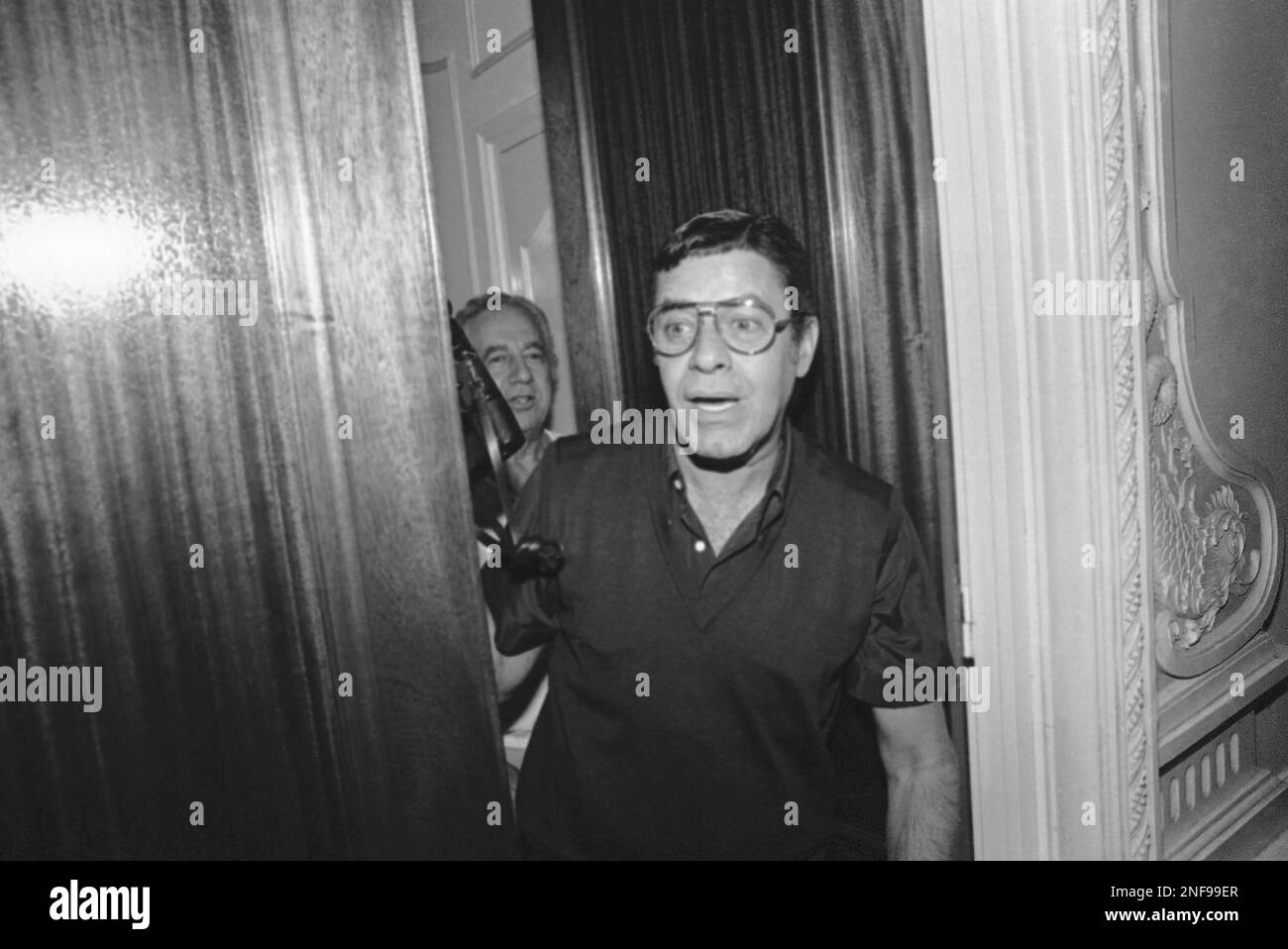 American comedic actor Jerry Lewis appears with camera on the door step ...