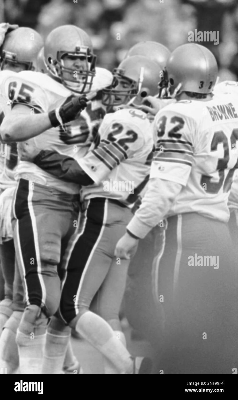 Boston College quarterback Doug Flutie (22) hugs offensive guard Steve ...