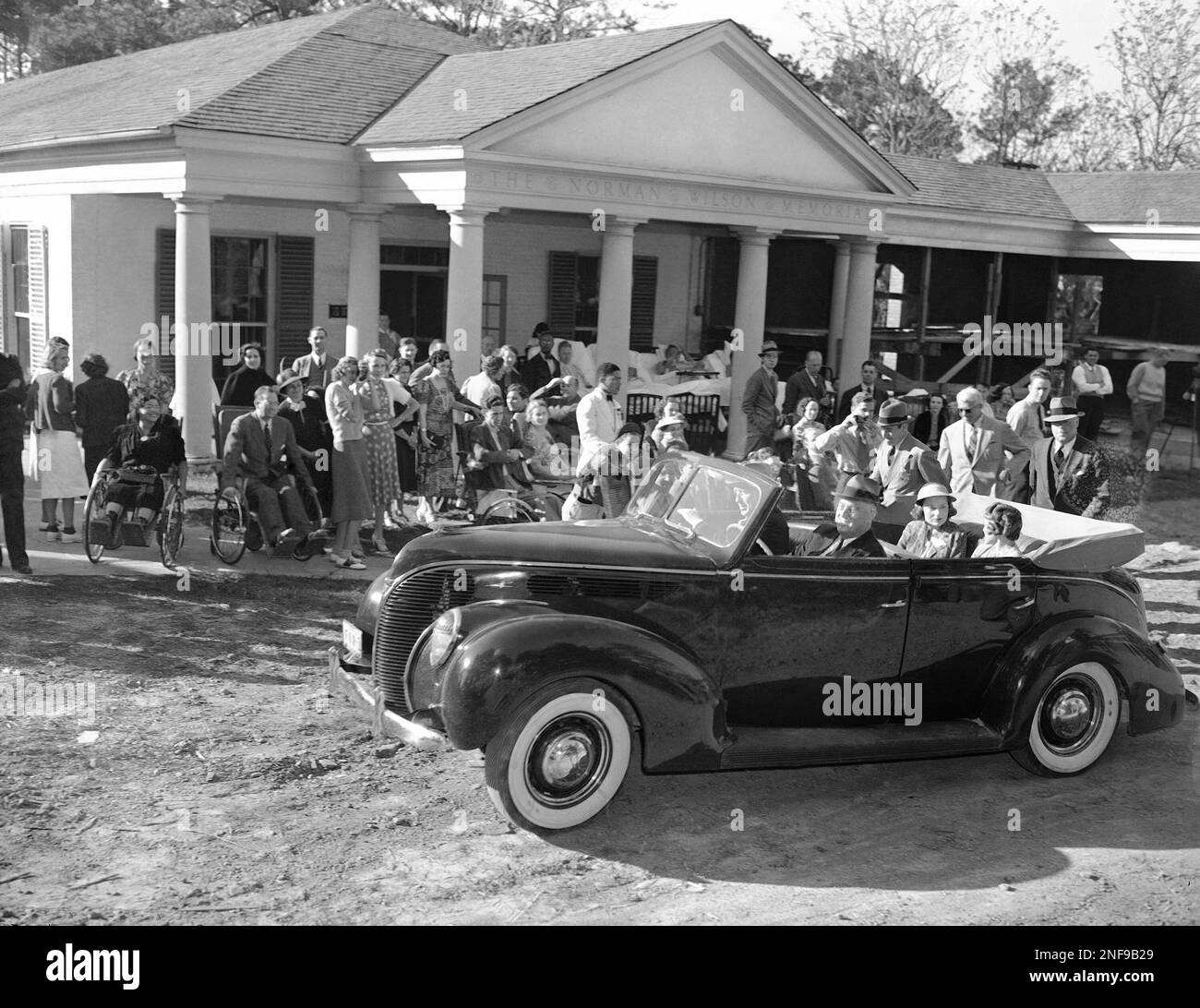 President Franklin D. Roosevelt is at the wheel of his automobile in ...