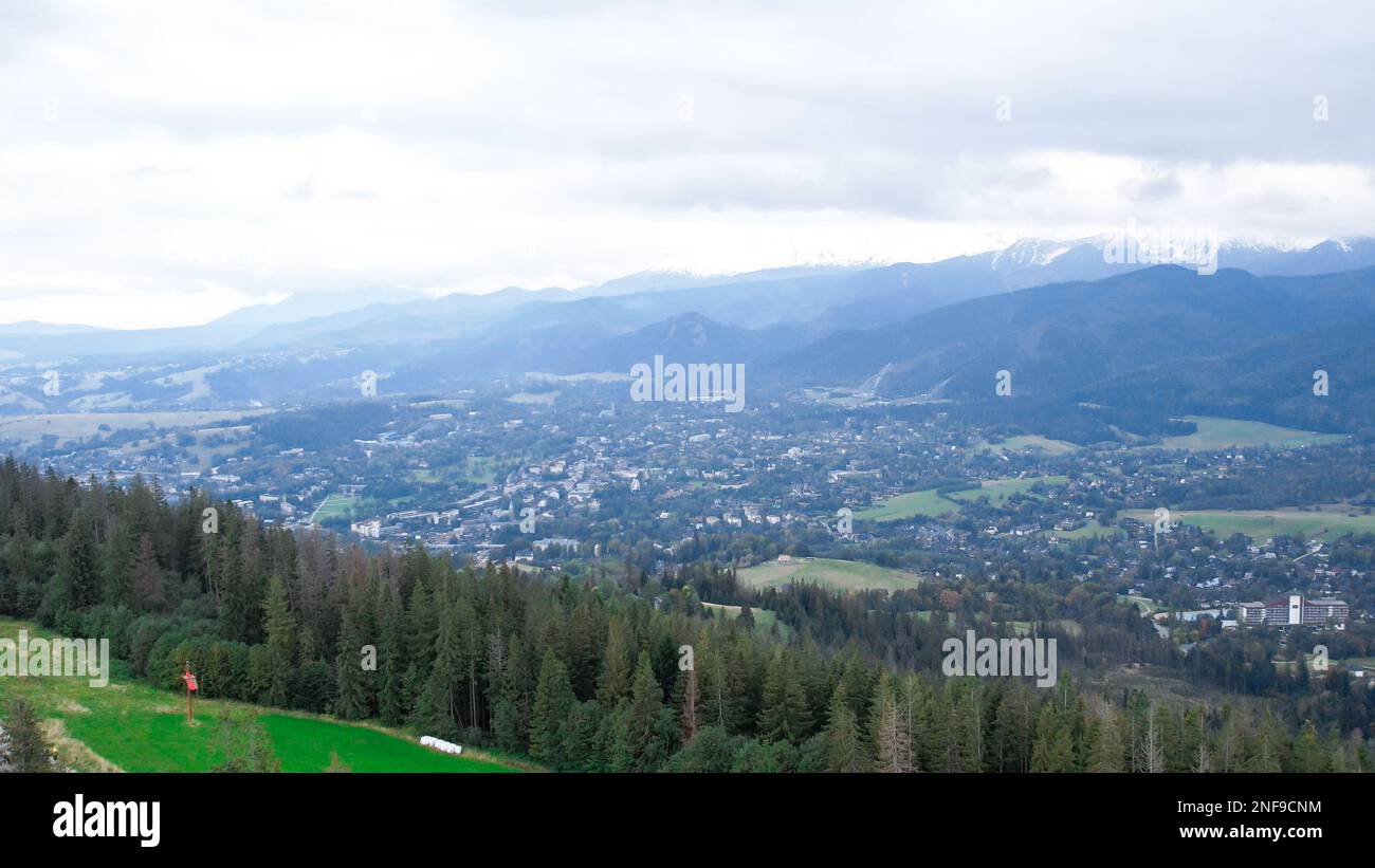 Aerial view of Zakopane town underneath Tatra Mountains taken from the ...