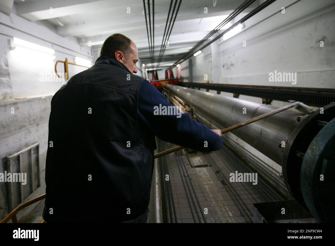The Eiffel tower's elevators supervisor Eric Trahand greases one of the ...