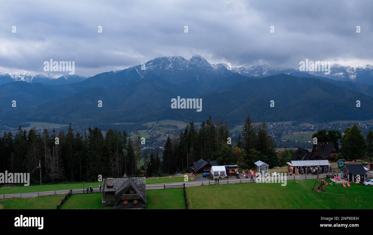 Aerial view of Zakopane town underneath Tatra Mountains taken from the ...