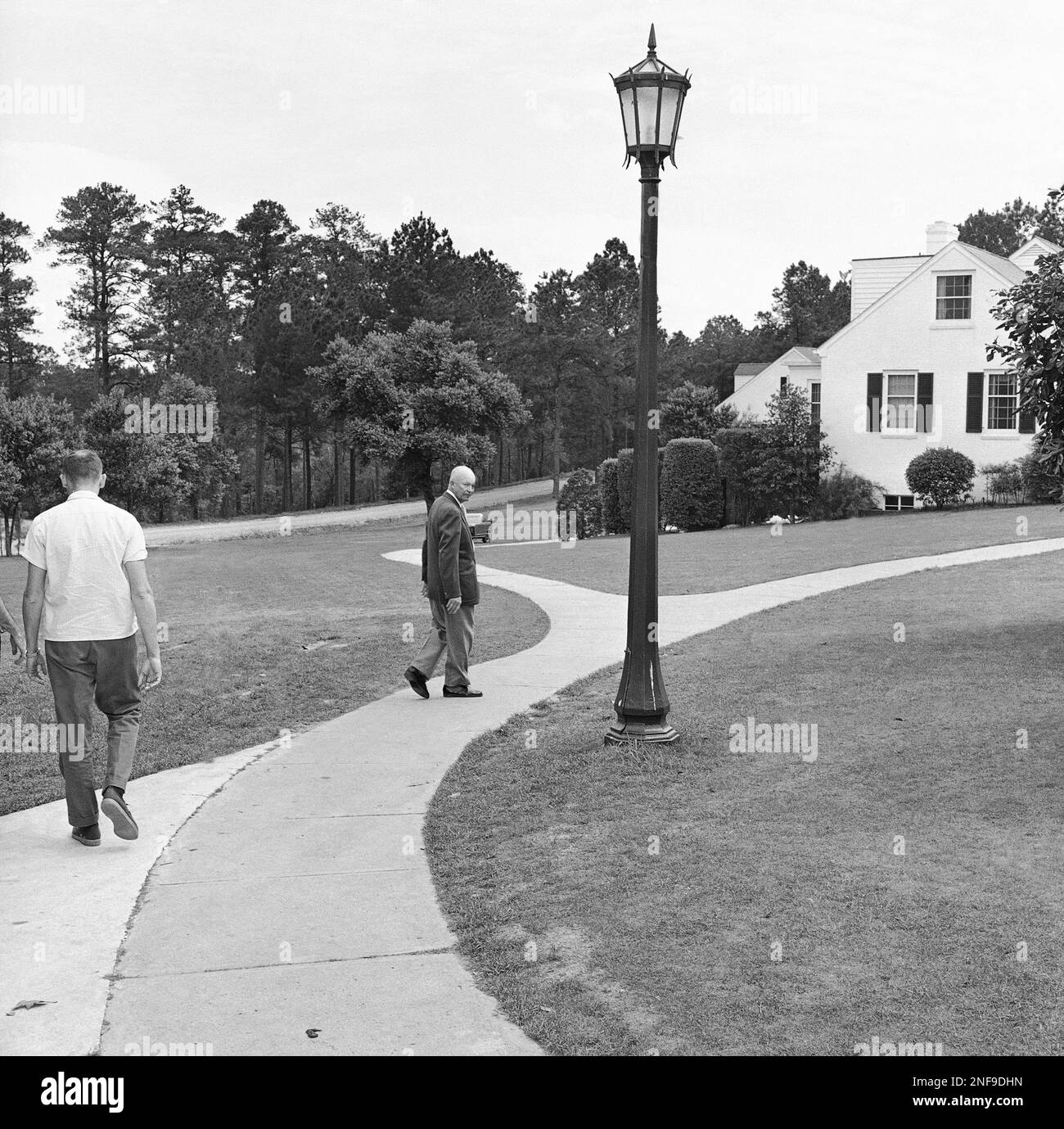 President Dwight Eisenhower takes a stroll in the sunshine at his ...