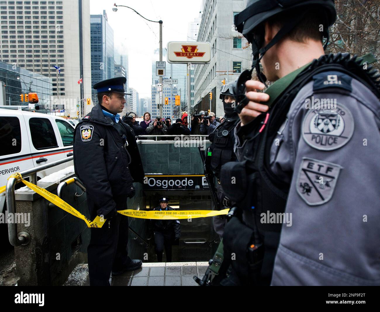 Toronto tactical police officers speak at the Osgoode subway line on ...