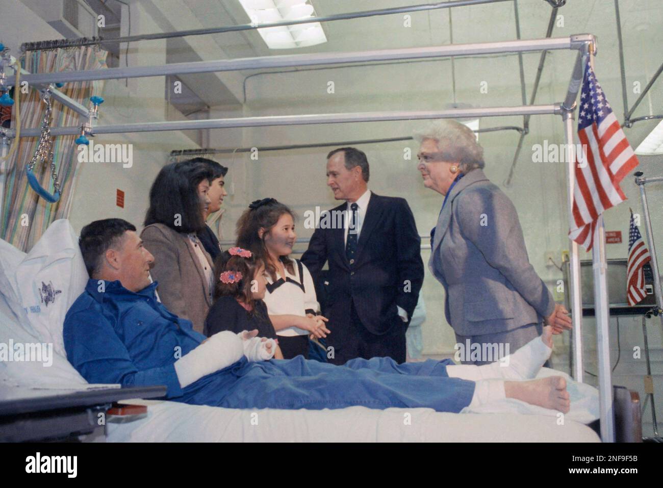 George H. Bush presents a tie tack to SFC James Almeida at Brook Army ...