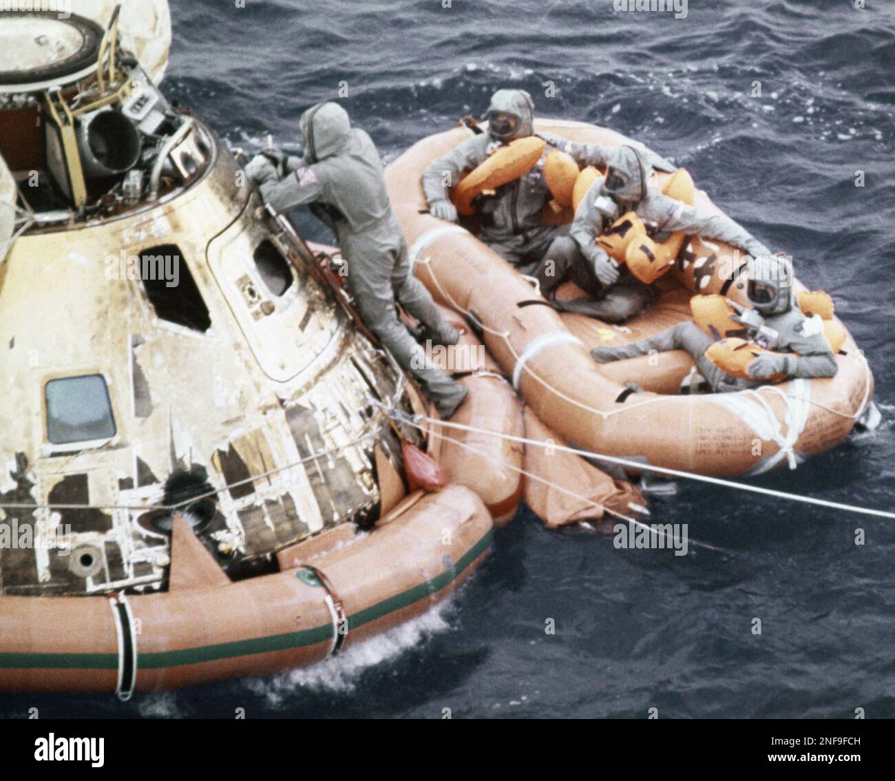 U.S. Navy personnel, protected by Biological Isolation Garments, are ...