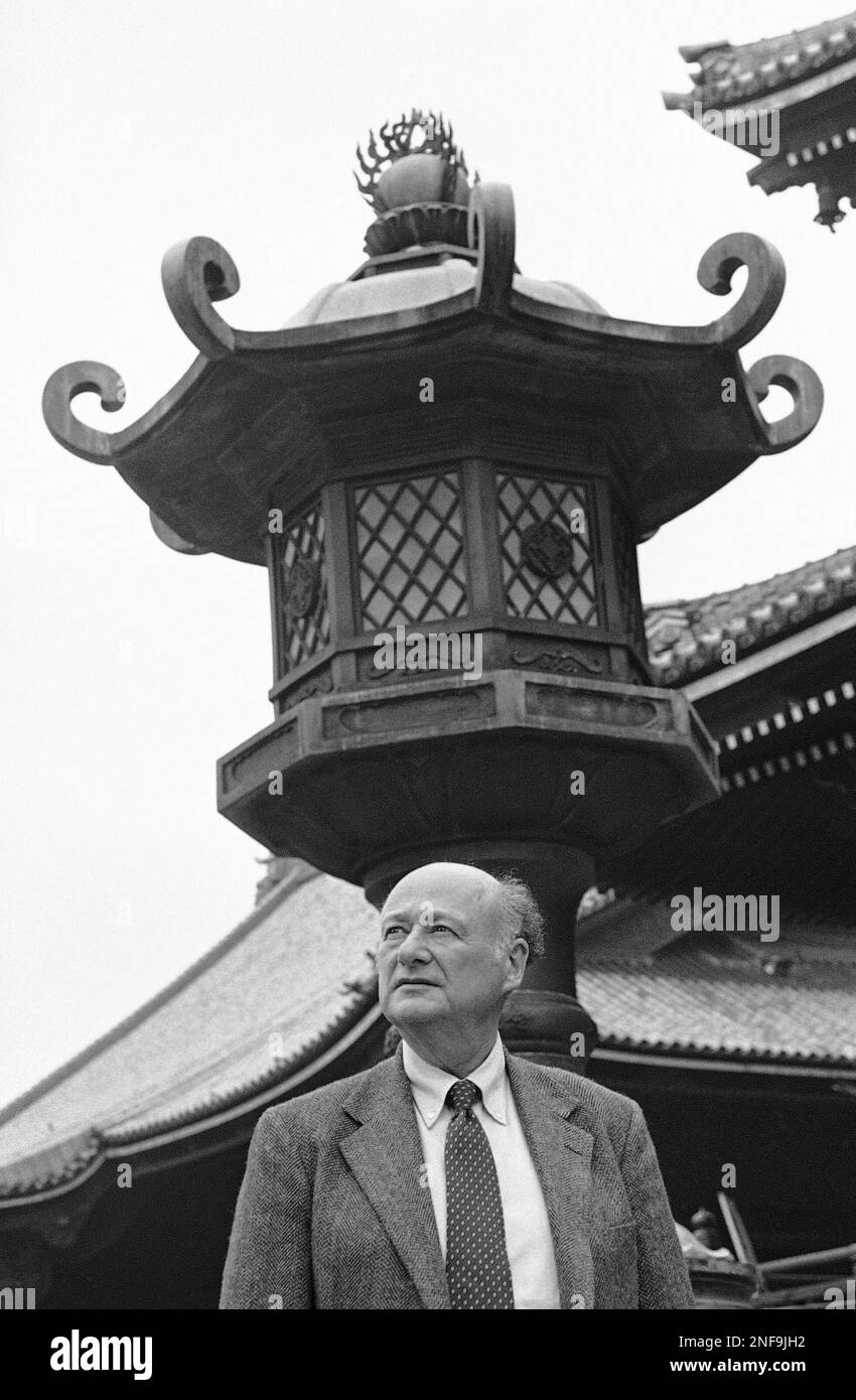 New York City Mayor Edward Koch stands under the large garden lantern ...