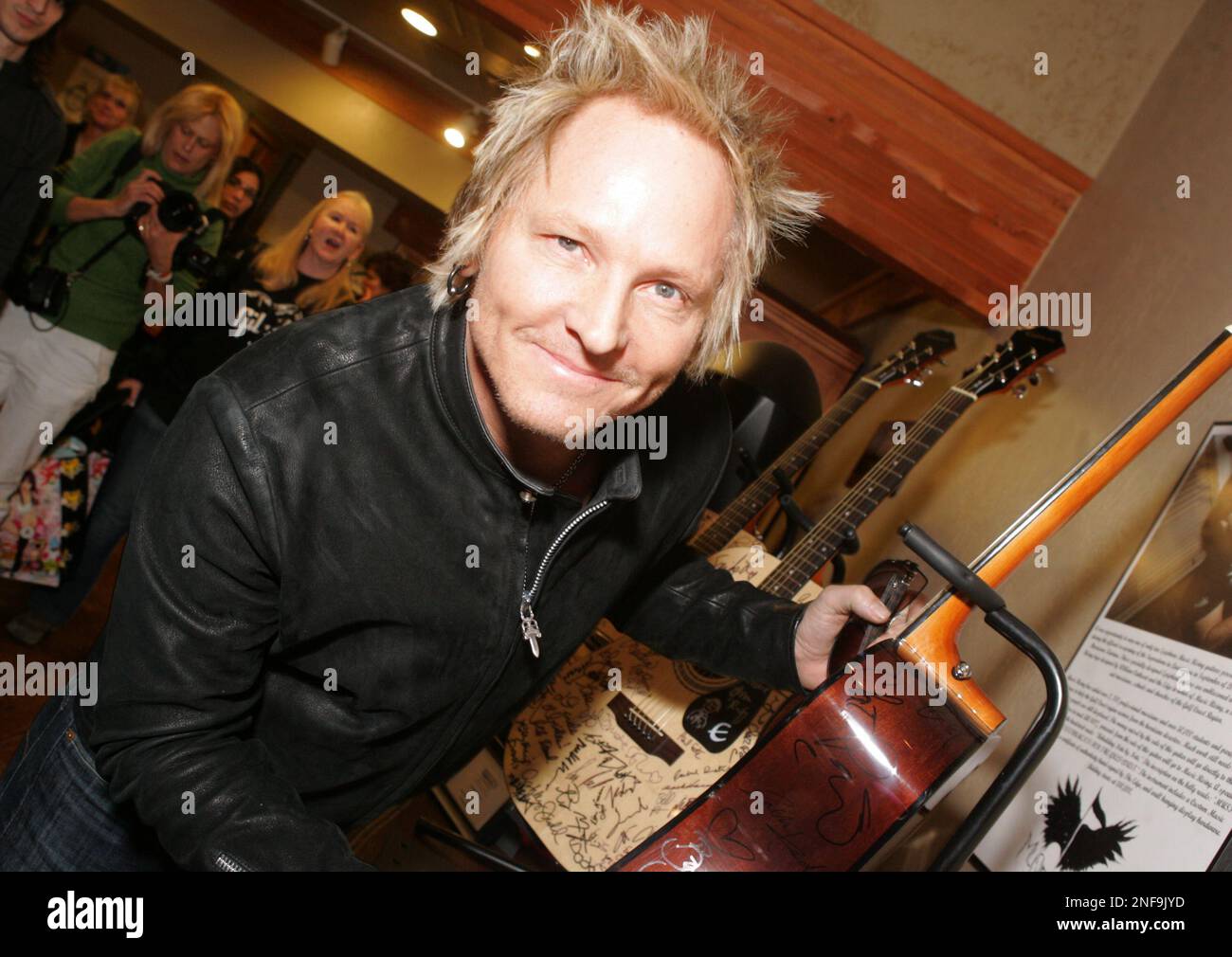 Musician Matt Sorum signs a guitar at the Gibson Guitar Lounge during ...