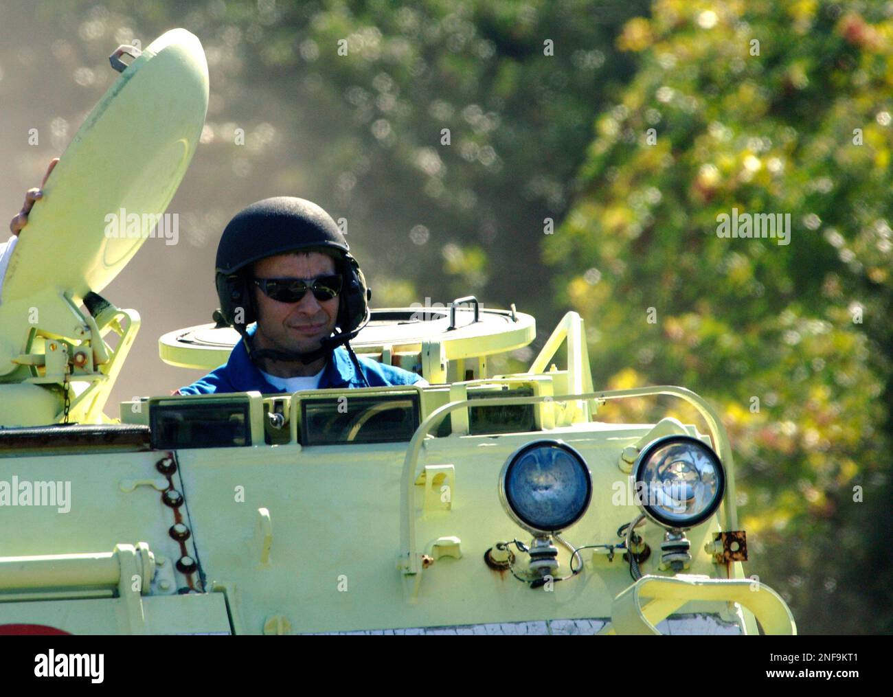 Space shuttle Discovery commander Lee Archambault takes a turn driving ...
