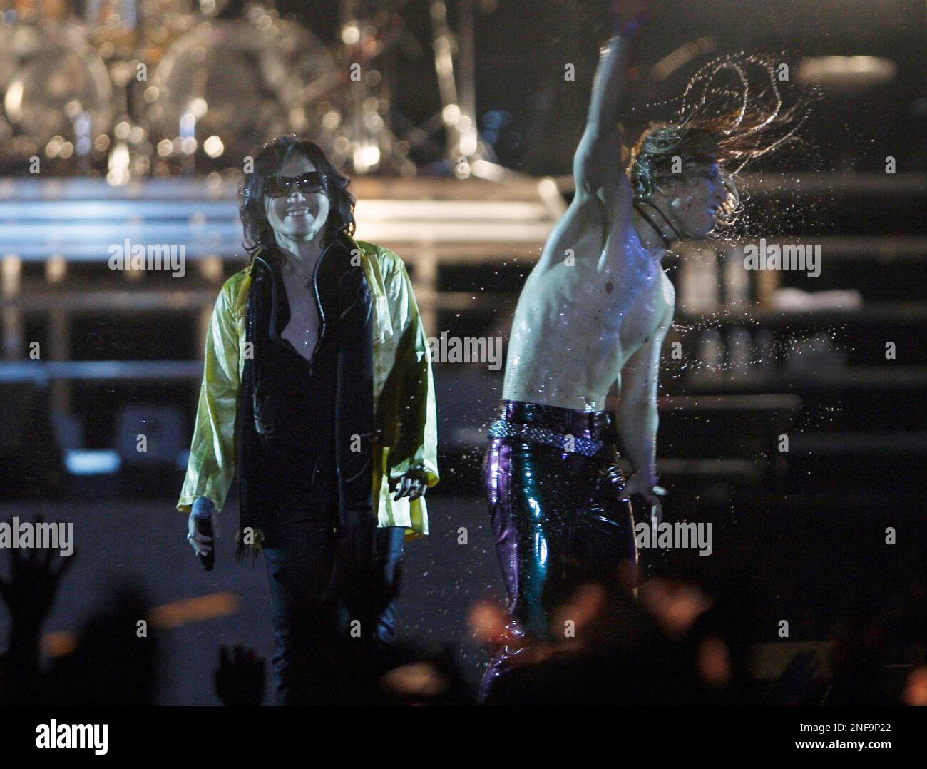 Japan's music band X Japan members Yoshiki Hayashi ,right, throws a ...