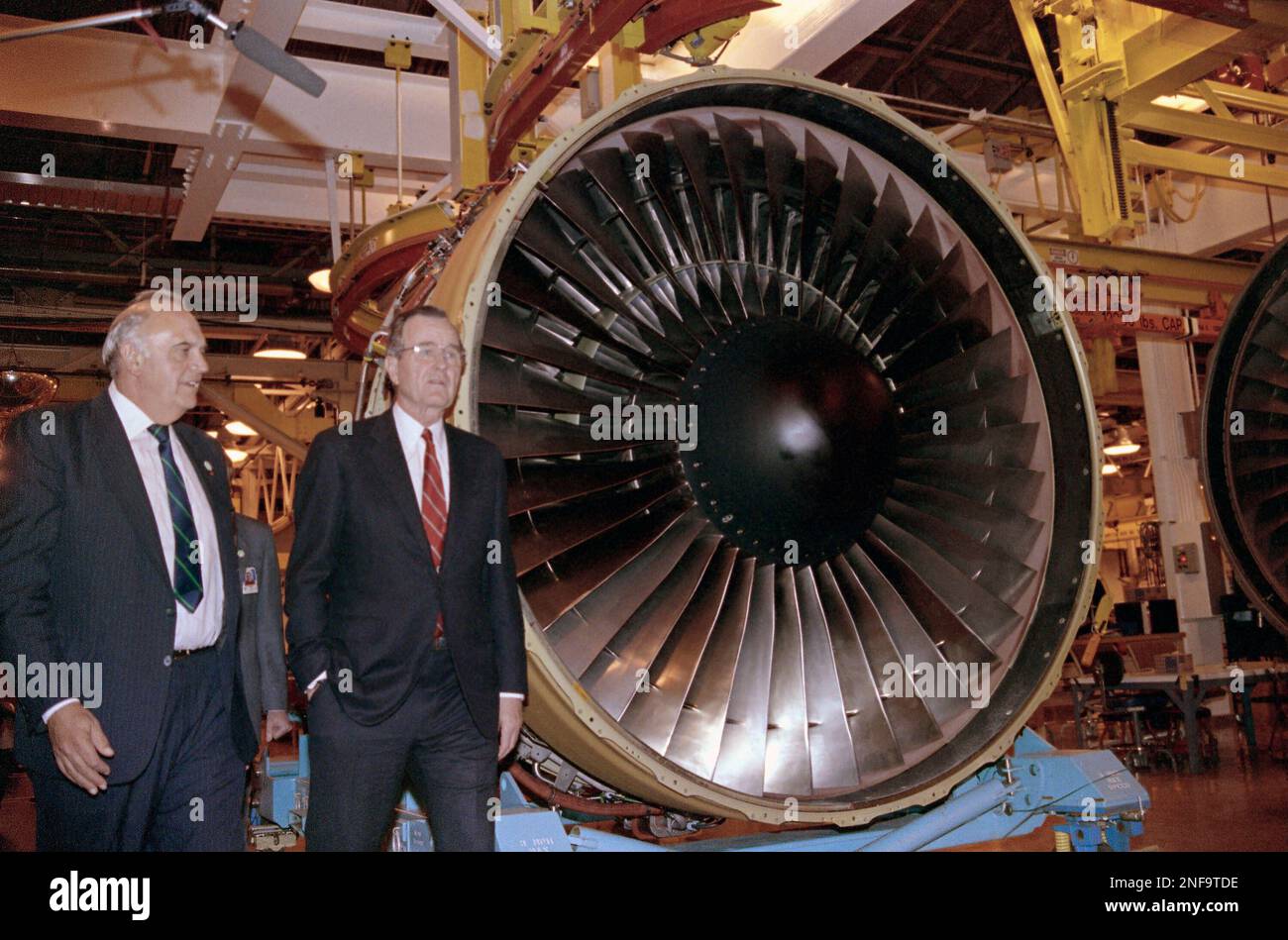 President George Bush talks with Brian Rowe, left, a senior vice ...