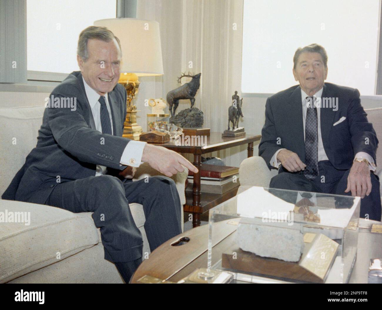 President George H. Bush point to a piece of the Berlin Wall while ...