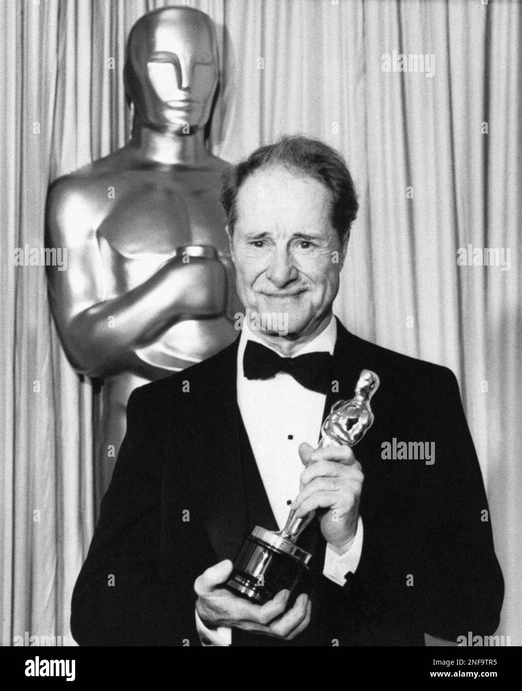 Veteran actor Don Ameche holds Oscar he won for best supporting actor ...