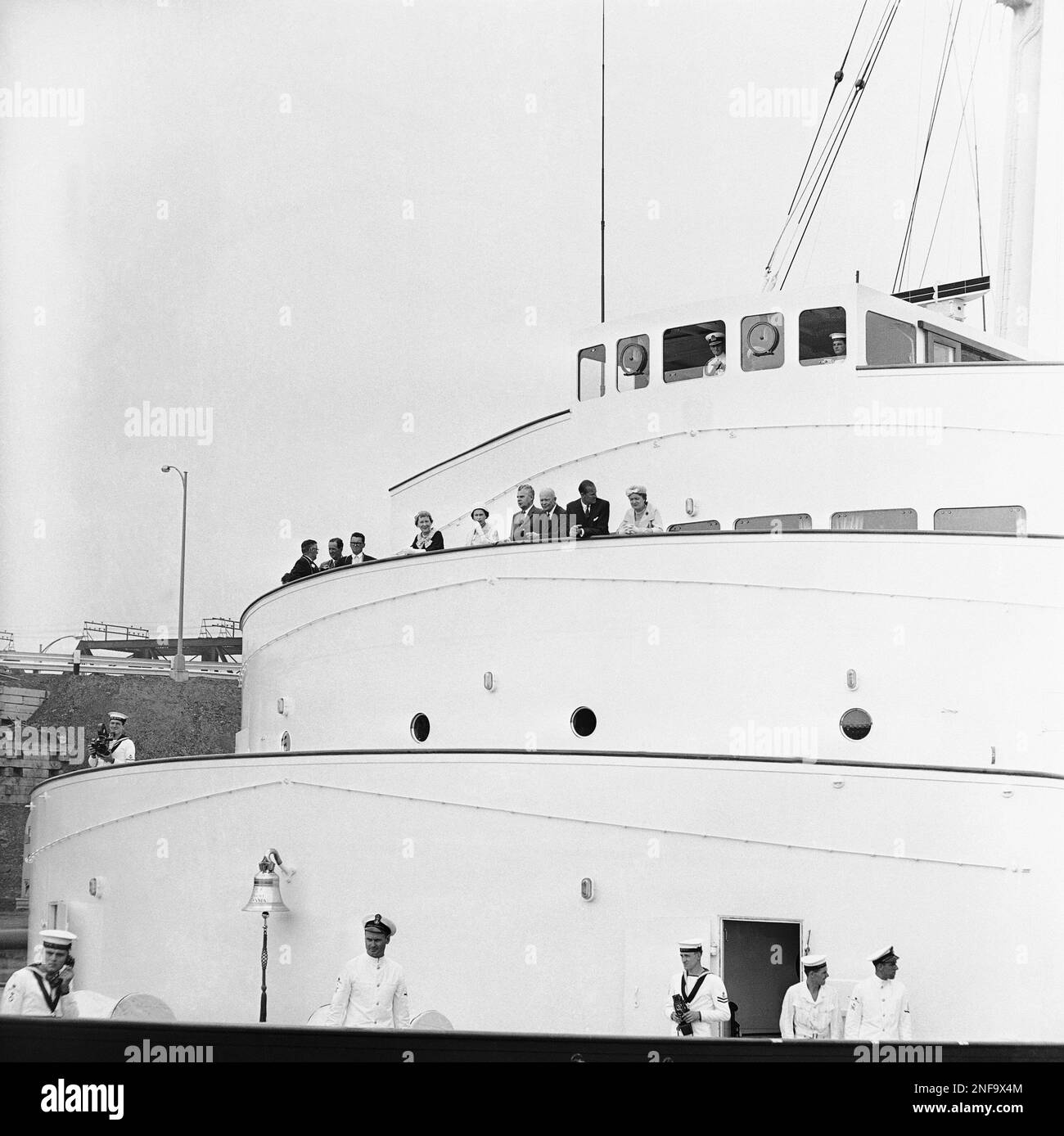 Lining the rail of the royal yacht Britannia as it moves up the St ...