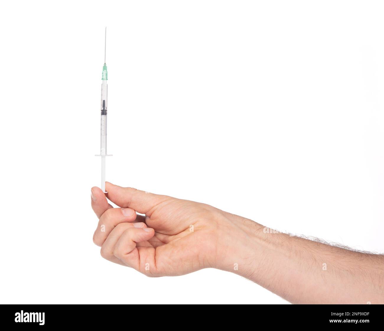 New syringe in adult hand on white background, medical and health care ...